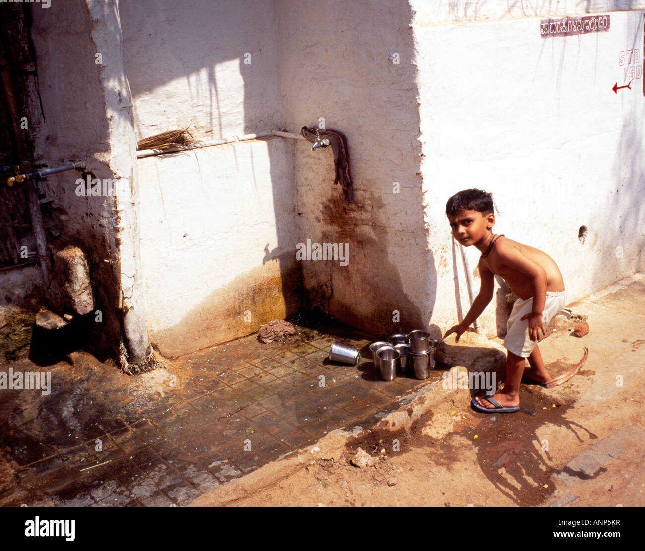 Indian boy washing hi-res stock photography and images - Alamy