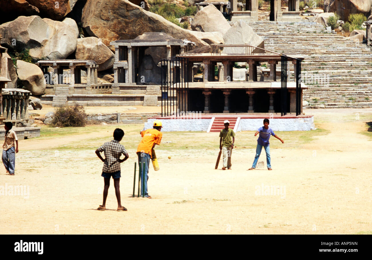Indian kids playing cricket in street hi-res stock photography and ...