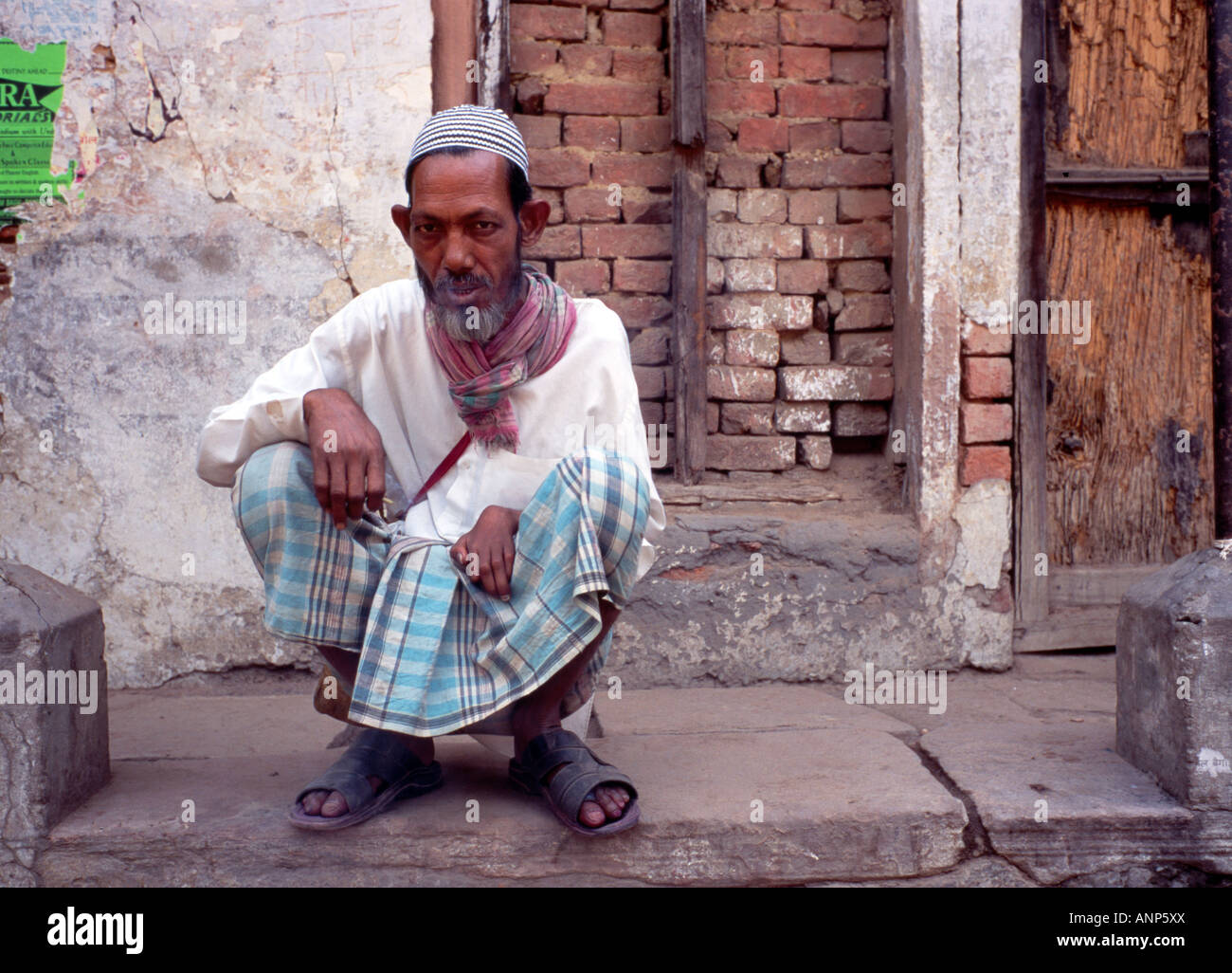 Indian man crouching on wall hi-res stock photography and images - Alamy