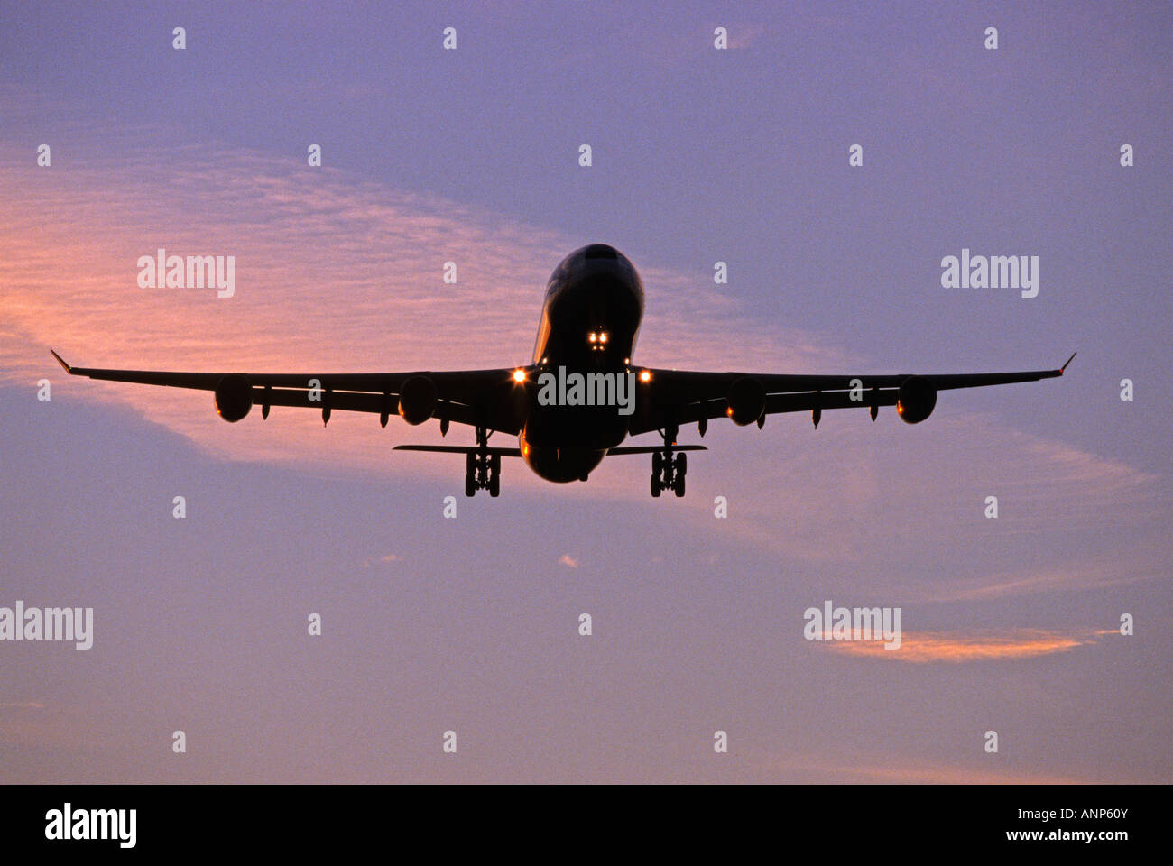 Airbus A340 passenger aircraft is to land at sunset Stock Photo - Alamy