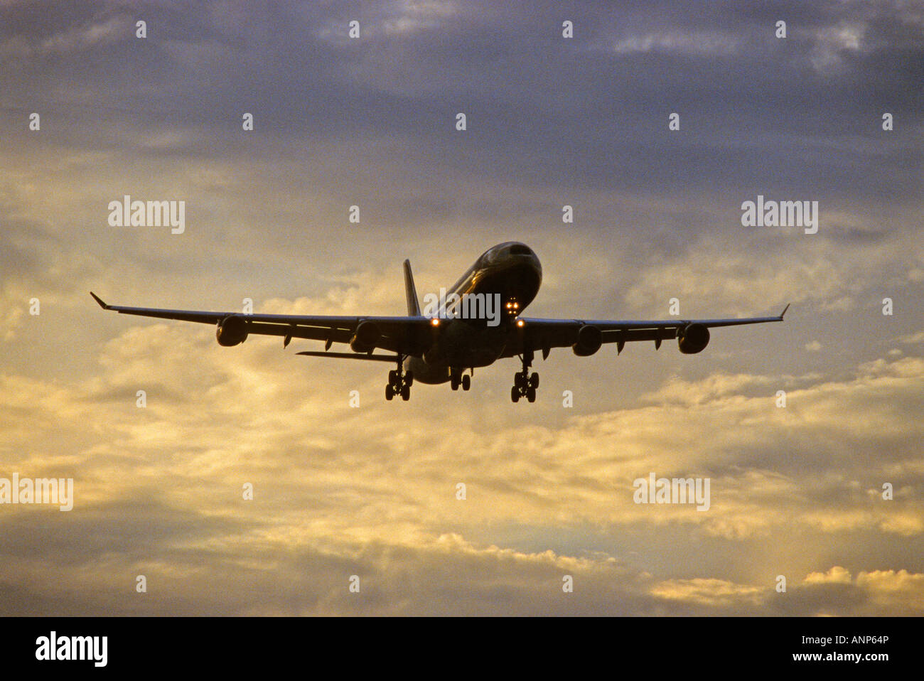 Airbus A340 passenger aircraft is to land at sunset Stock Photo - Alamy