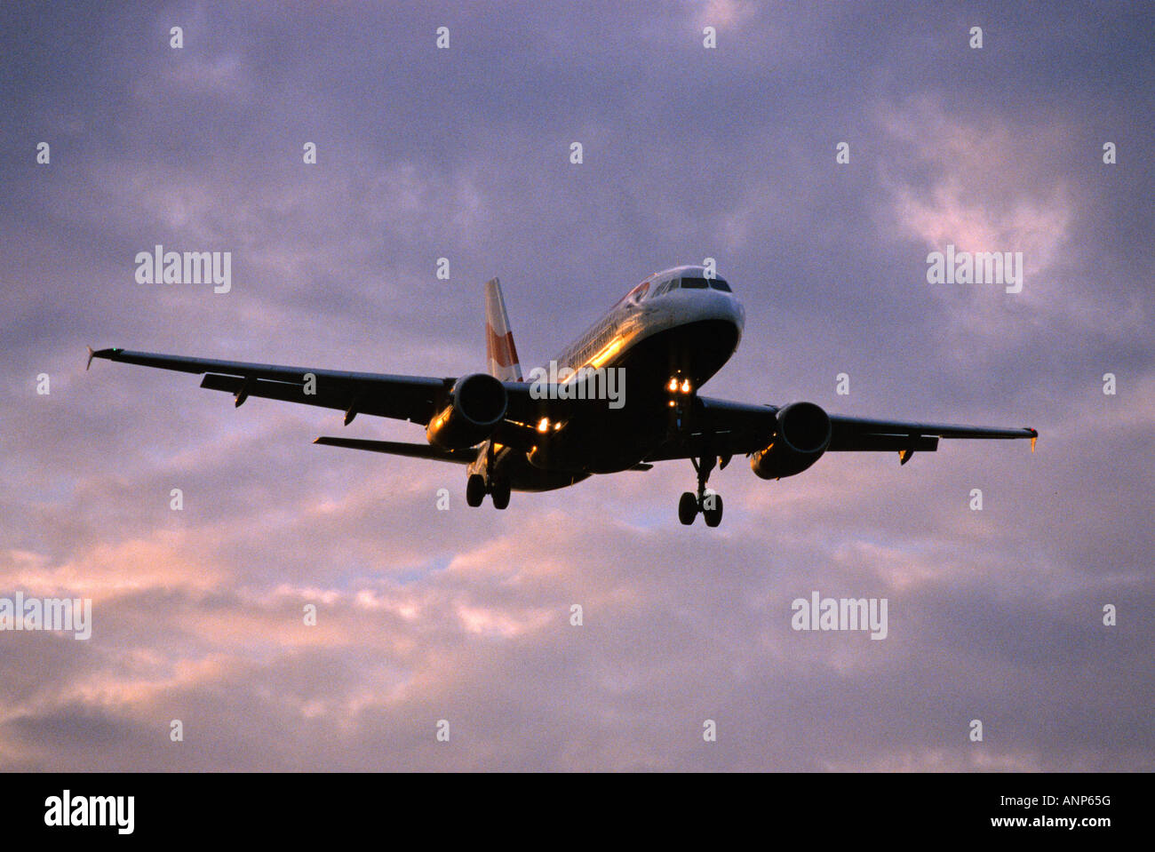 Airbus A320 is Approaching to Land at Sunset Stock Photo - Alamy