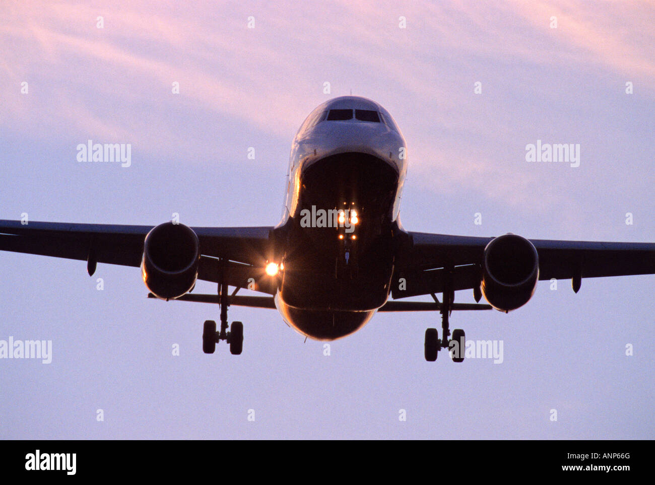 Airbus A320 is Approaching to Land at Sunset Stock Photo - Alamy
