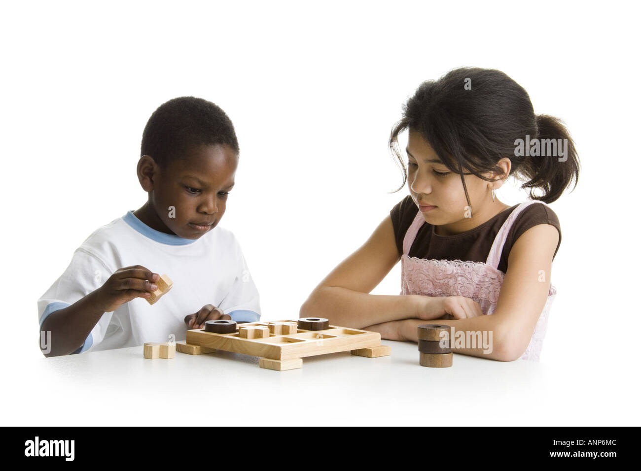 Close up of a boy and a girl playing a board game Stock Photo - Alamy