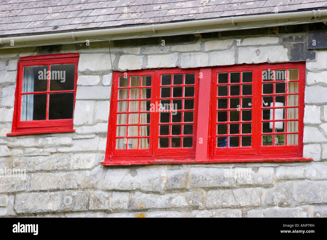 Interesting windows with painted red frames Stock Photo - Alamy