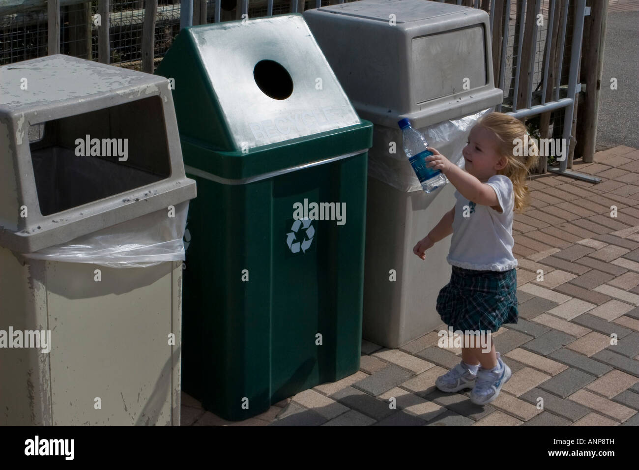 Little Girl Disposing of Garbage Stock Photo - Alamy