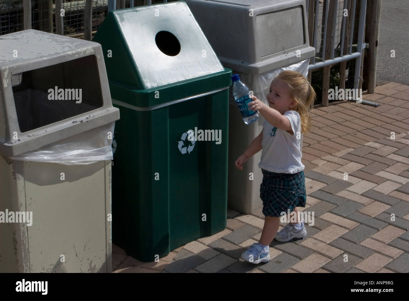 Little Girl Disposing of Garbage Stock Photo - Alamy