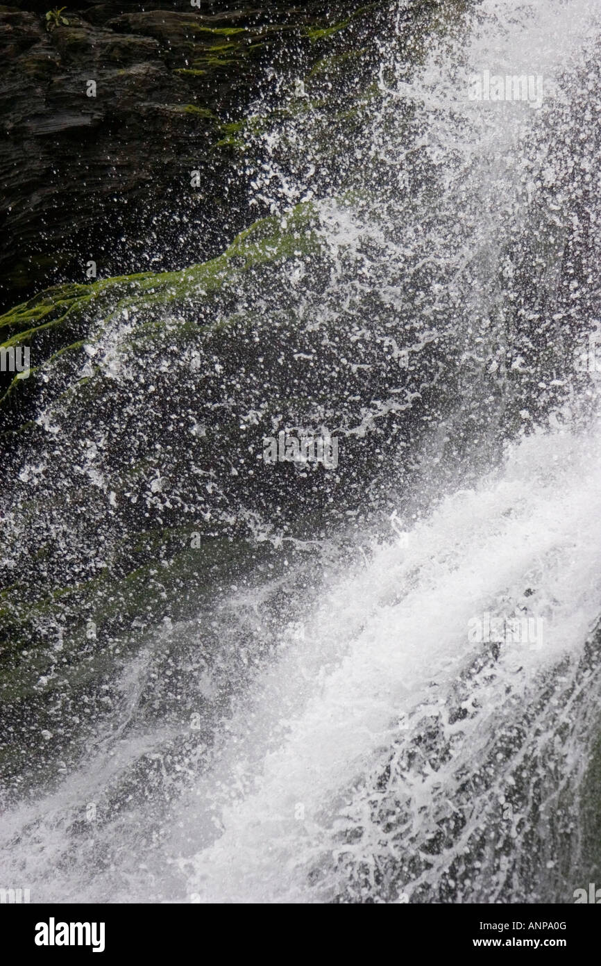 Waterfall cascading onto the beach underneath the ancient castle in ...
