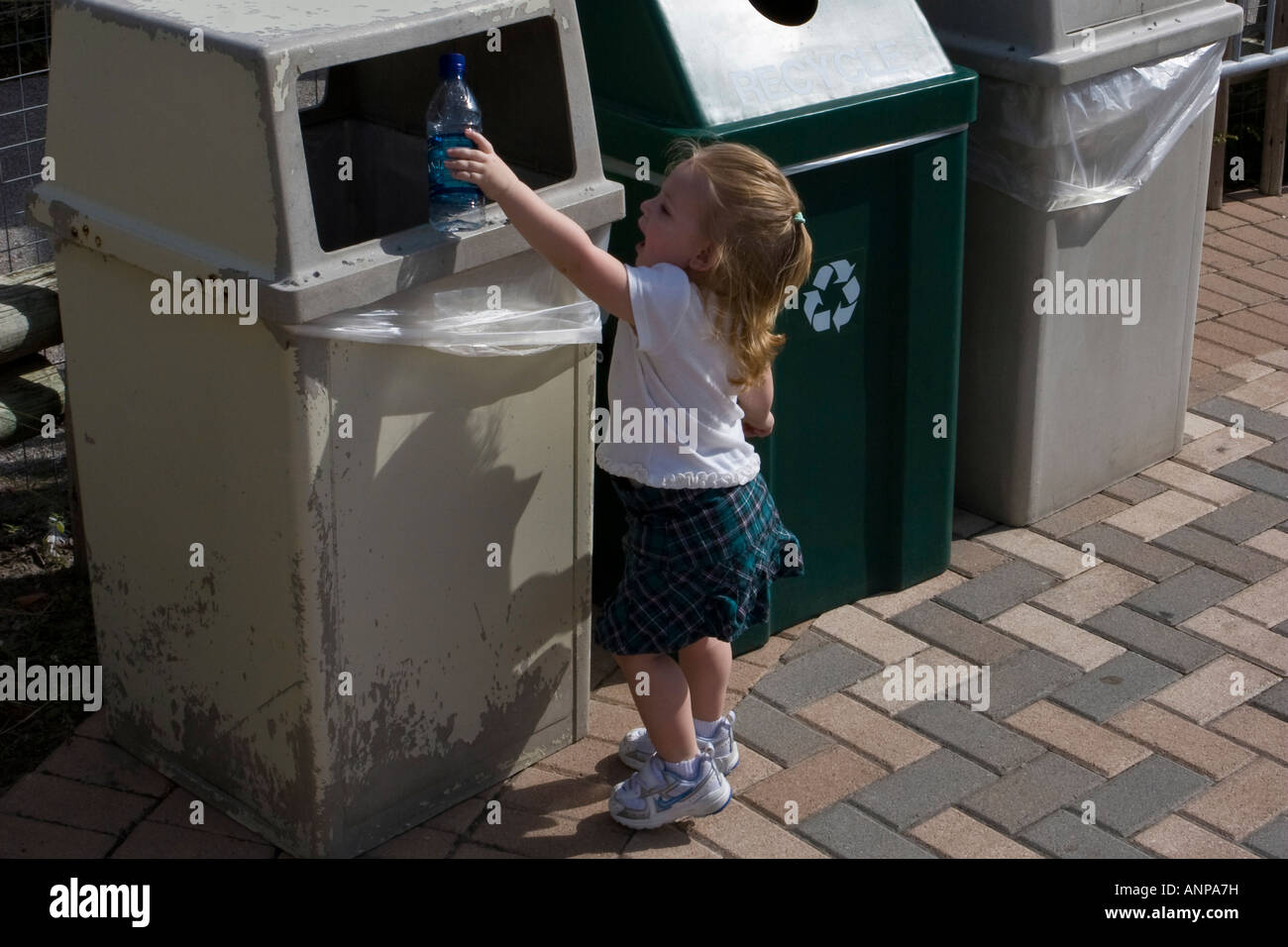 Little Girl Disposing of Garbage Stock Photo - Alamy