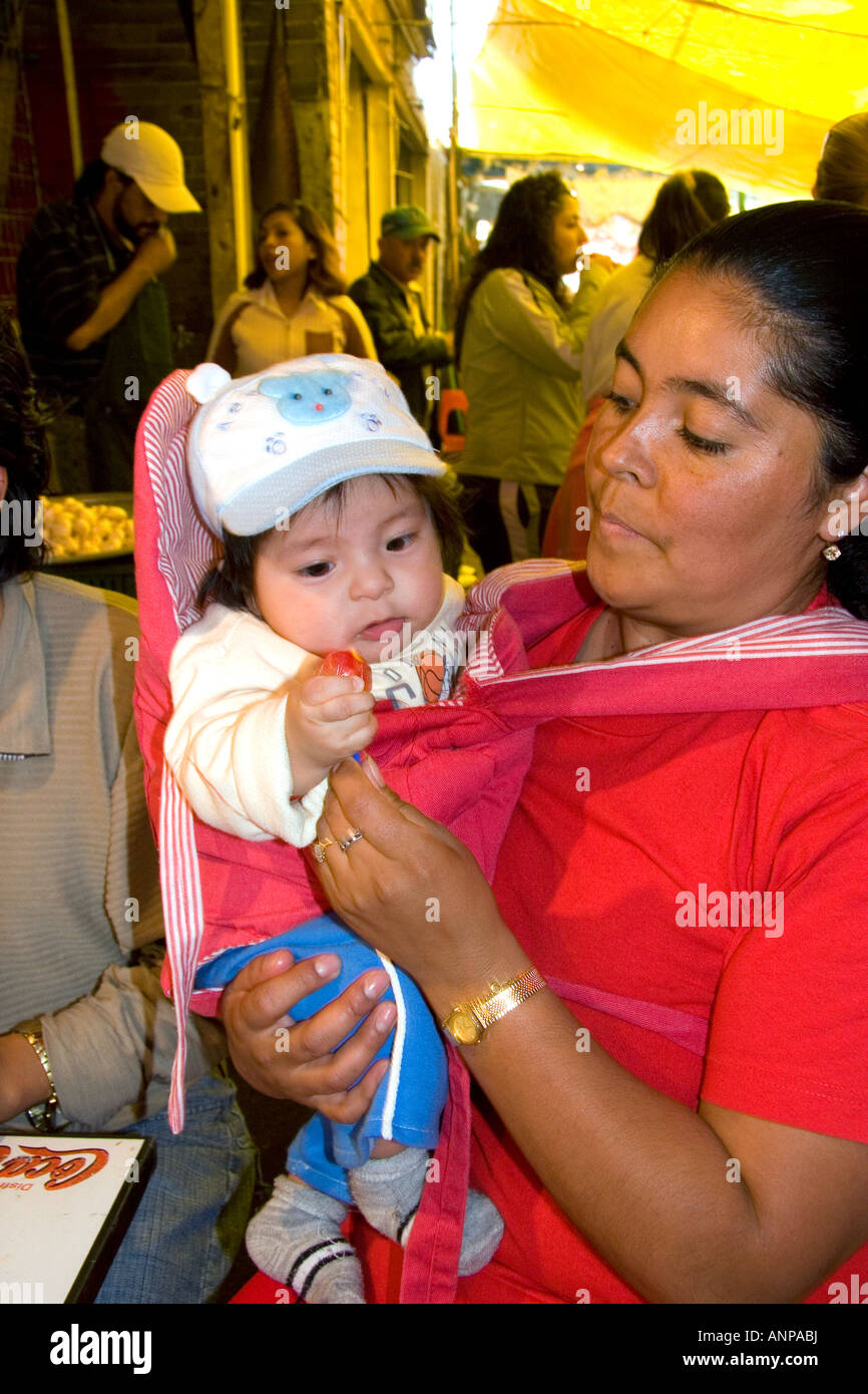 Mexican woman and her infant child at the Merced Market in Mexico City ...
