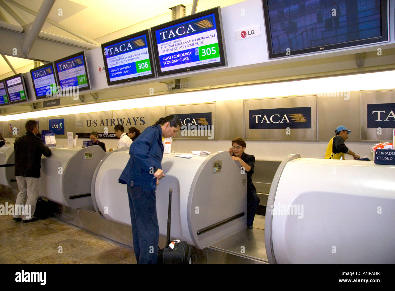 Travelers at the TACA airlines ticket counter at the Mexico City ...