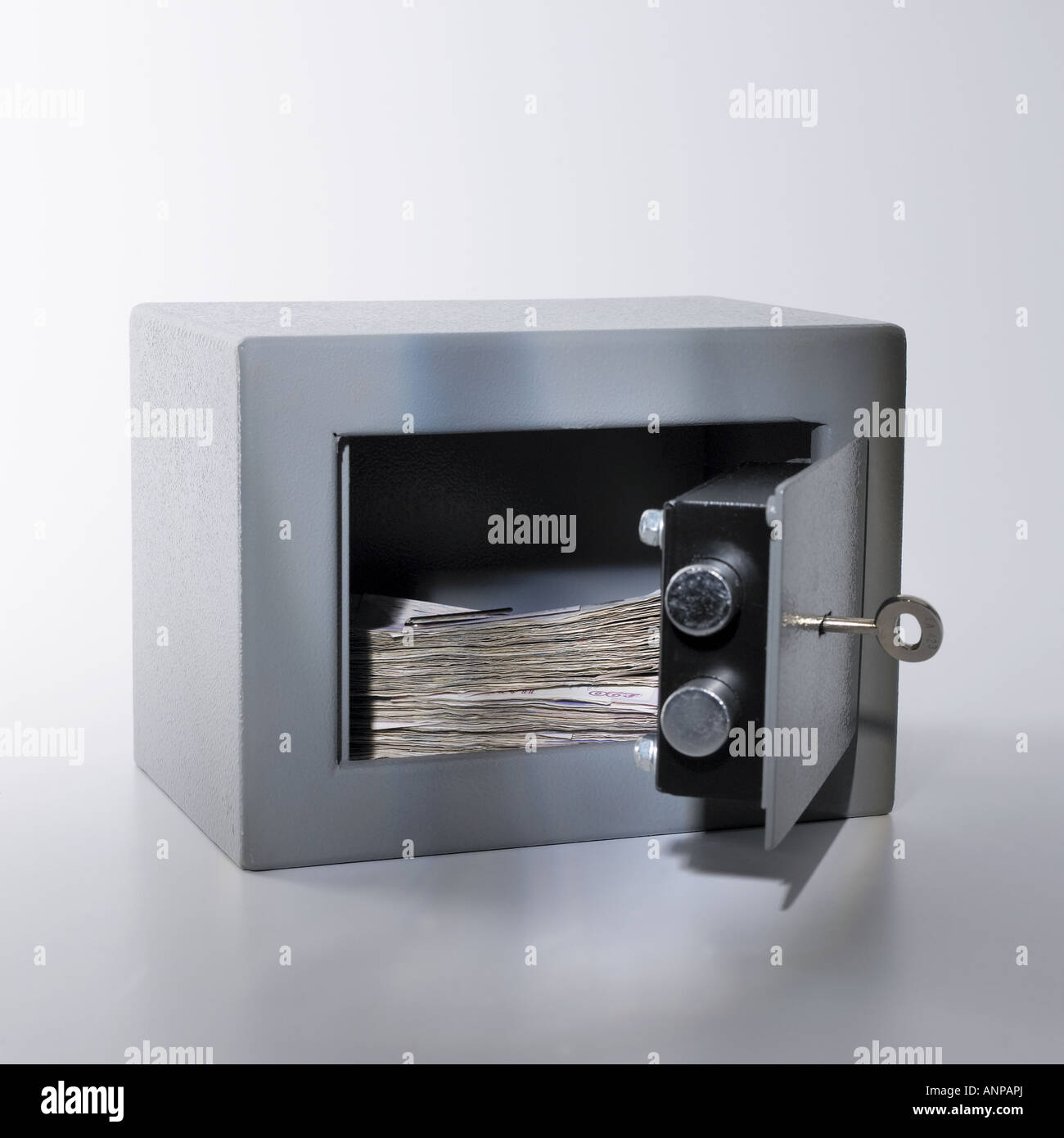 savings cash in home safe or bank under lock and key Stock Photo - Alamy