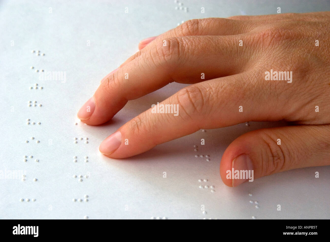 Hand reading braille Stock Photo - Alamy