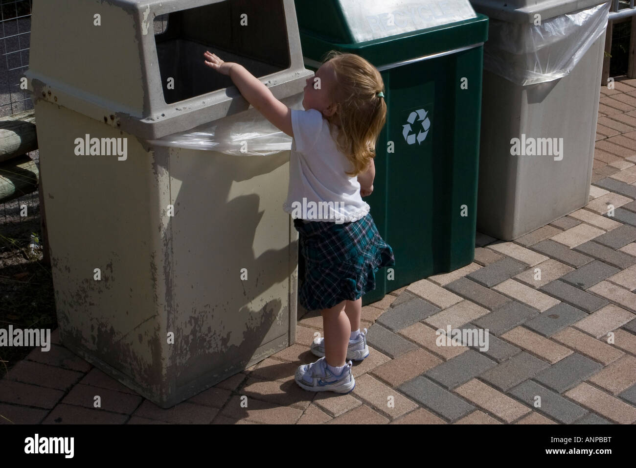 Little Girl Disposing of Garbage Stock Photo - Alamy