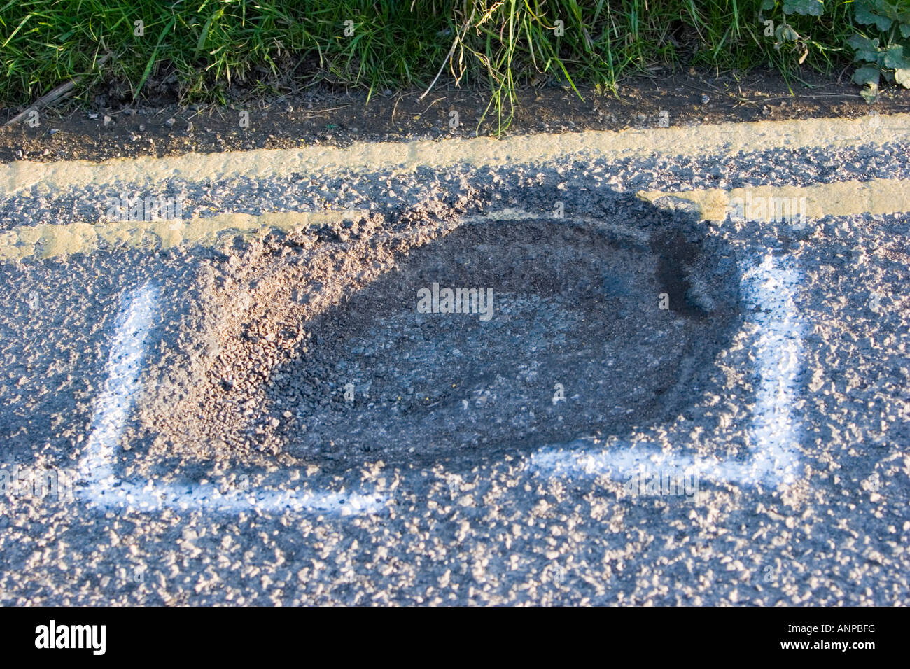 Pothole damage in the tarmac road surface Stock Photo - Alamy