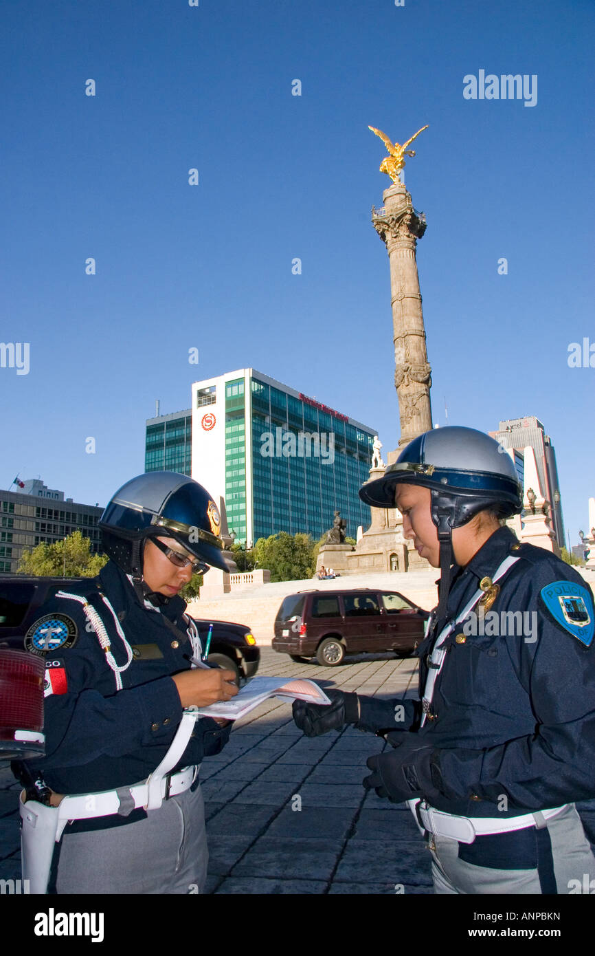Female police officers write a traffic ticket in front of the Angel de ...