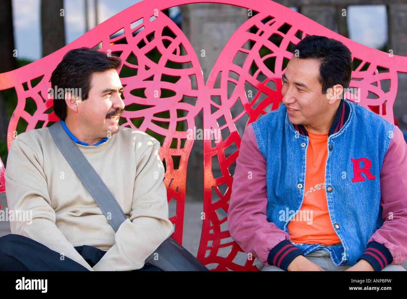 Mexican men talk while sitting on a public art bench along the Paseo de ...