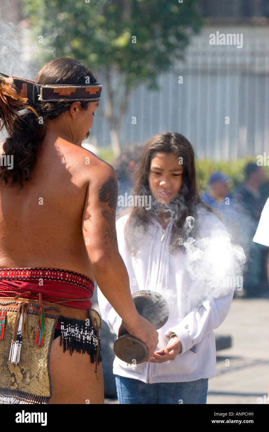 Aztec indian in traditional dress performing a spiritual ceremony using ...