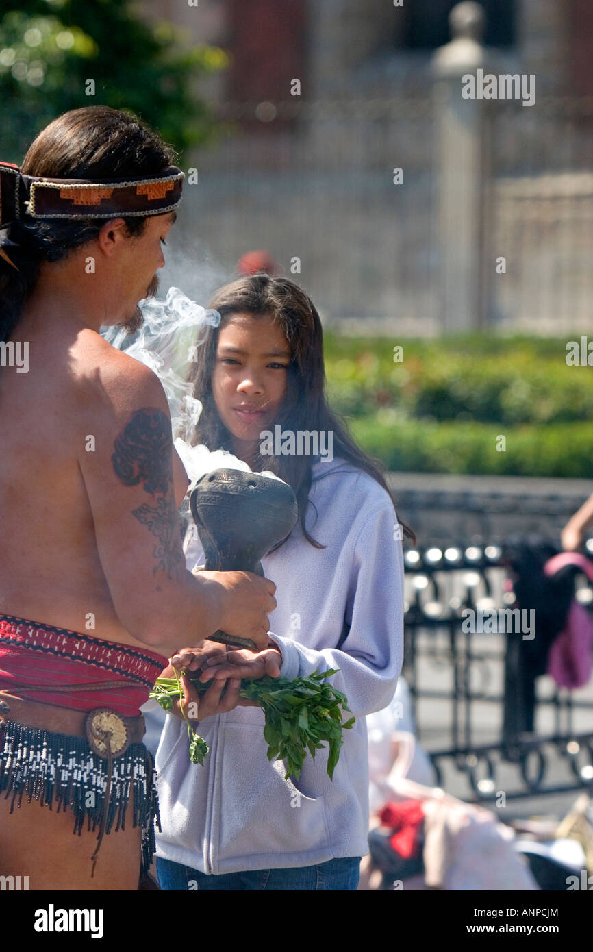 Aztec indian in traditional dress performing a spiritual ceremony using ...