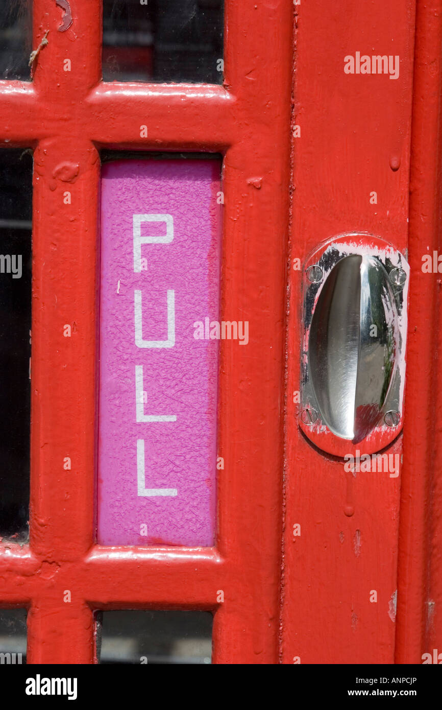 Pull handle on traditional red telephone box Stock Photo - Alamy