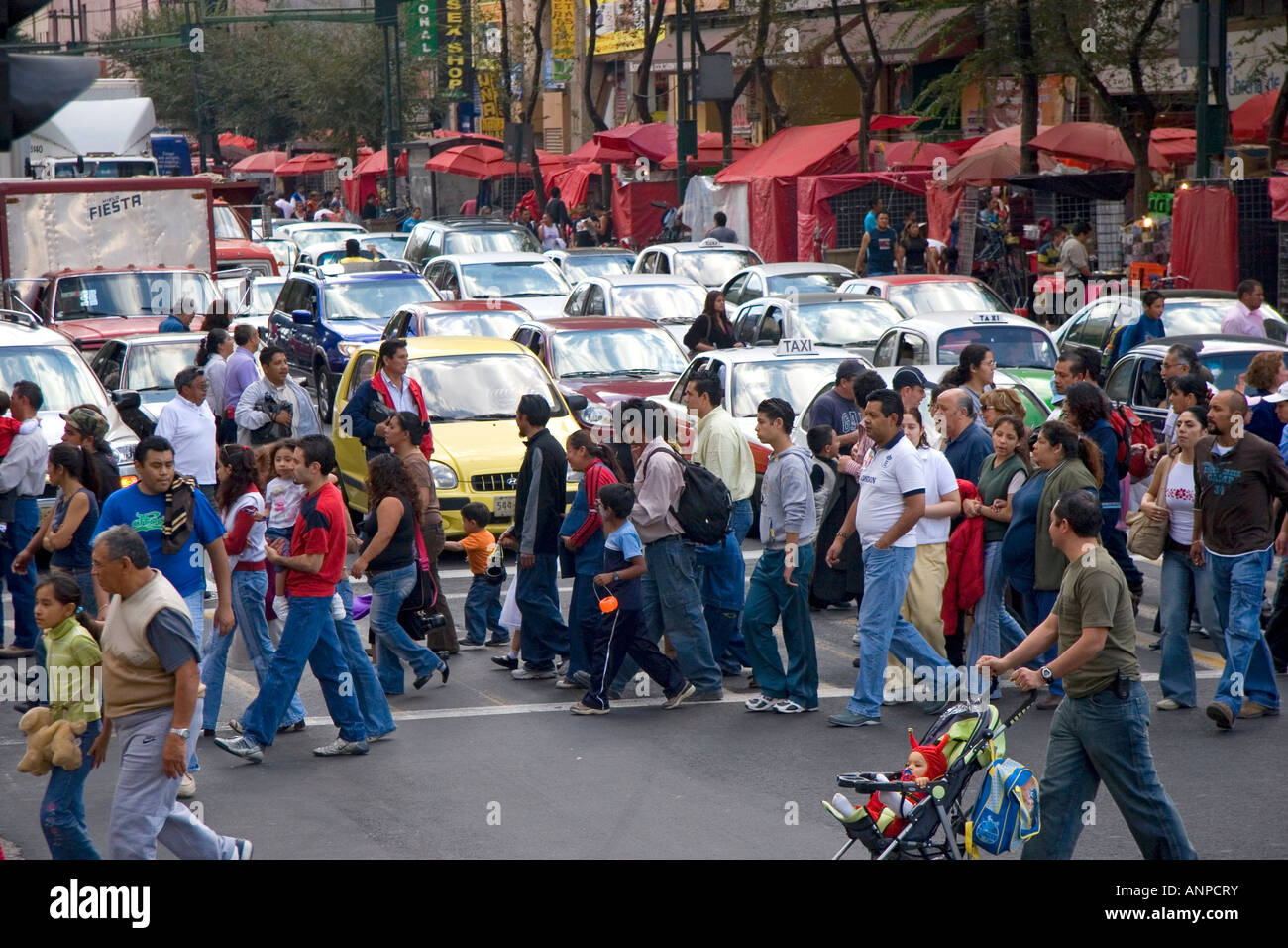 Pedestrians cross the street at the intersection of Paseo de la Reforma ...