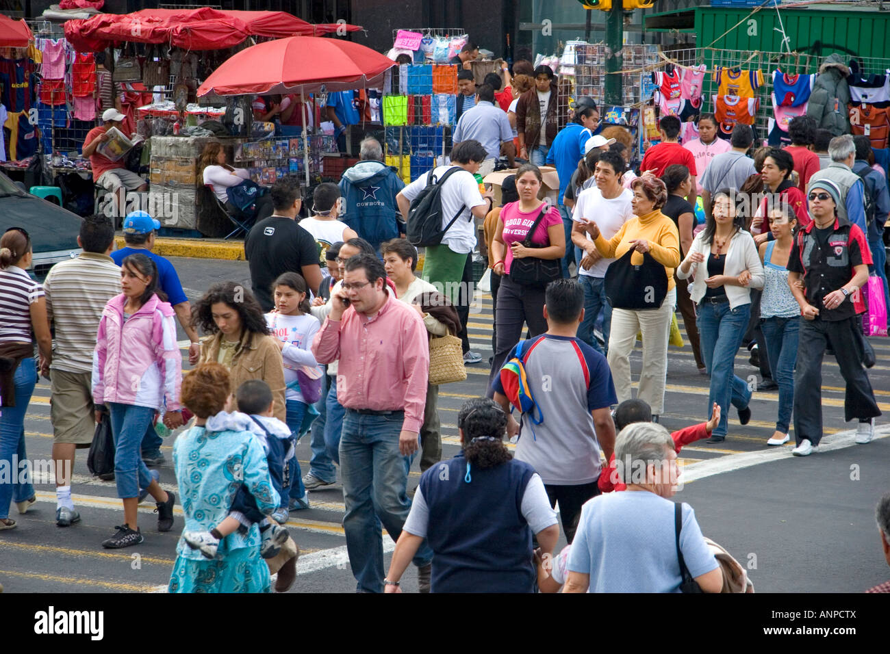 Pedestrians cross the street at the intersection of Paseo de la Reforma ...