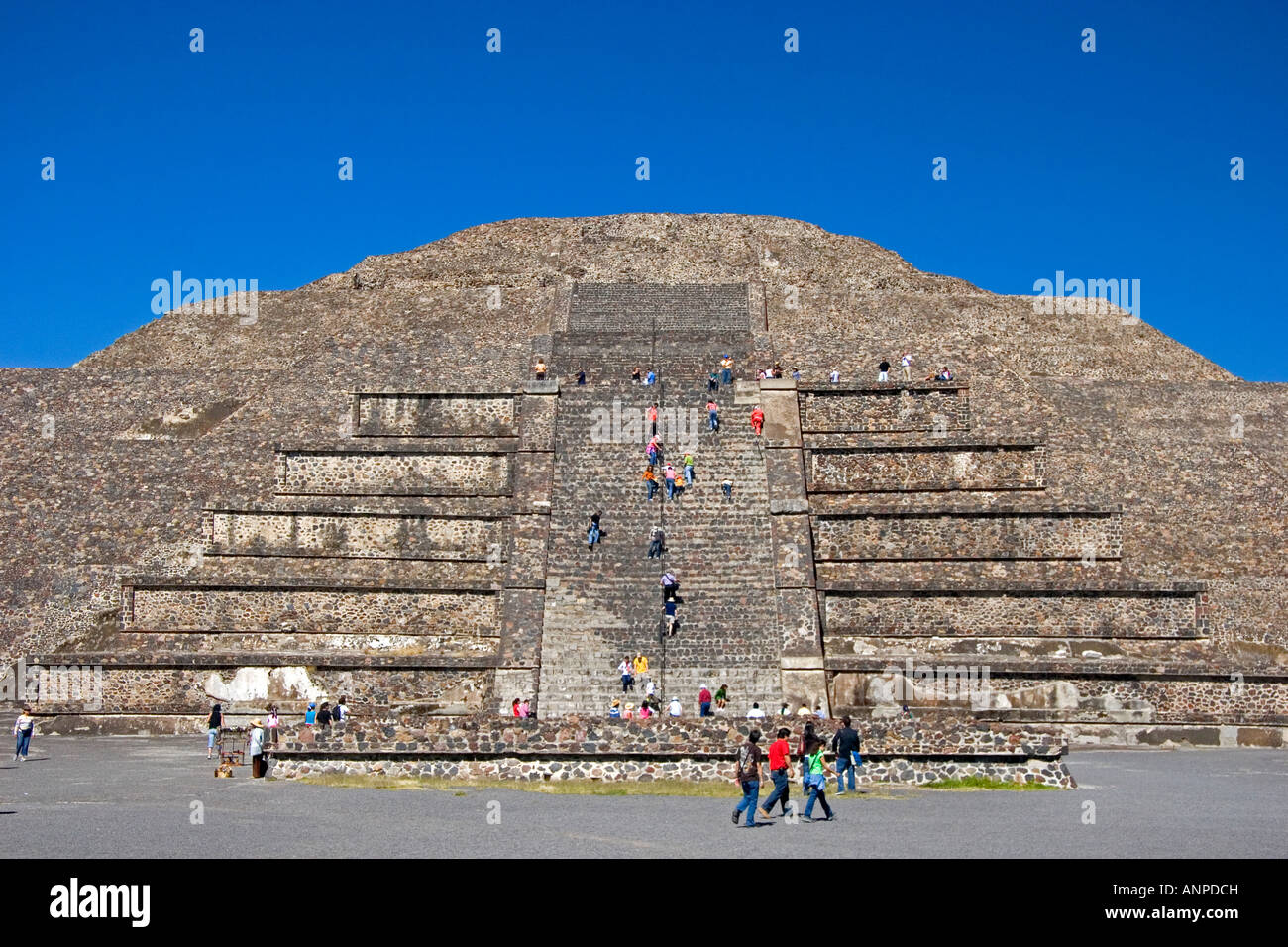 Tourists visit the Pyramid of the Moon at Teotihuacan in the State of ...