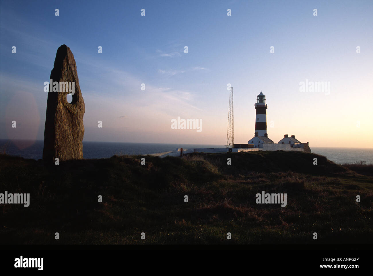 The old head of Kinsale lighthouse and standing stone, Cork, Ireland ...