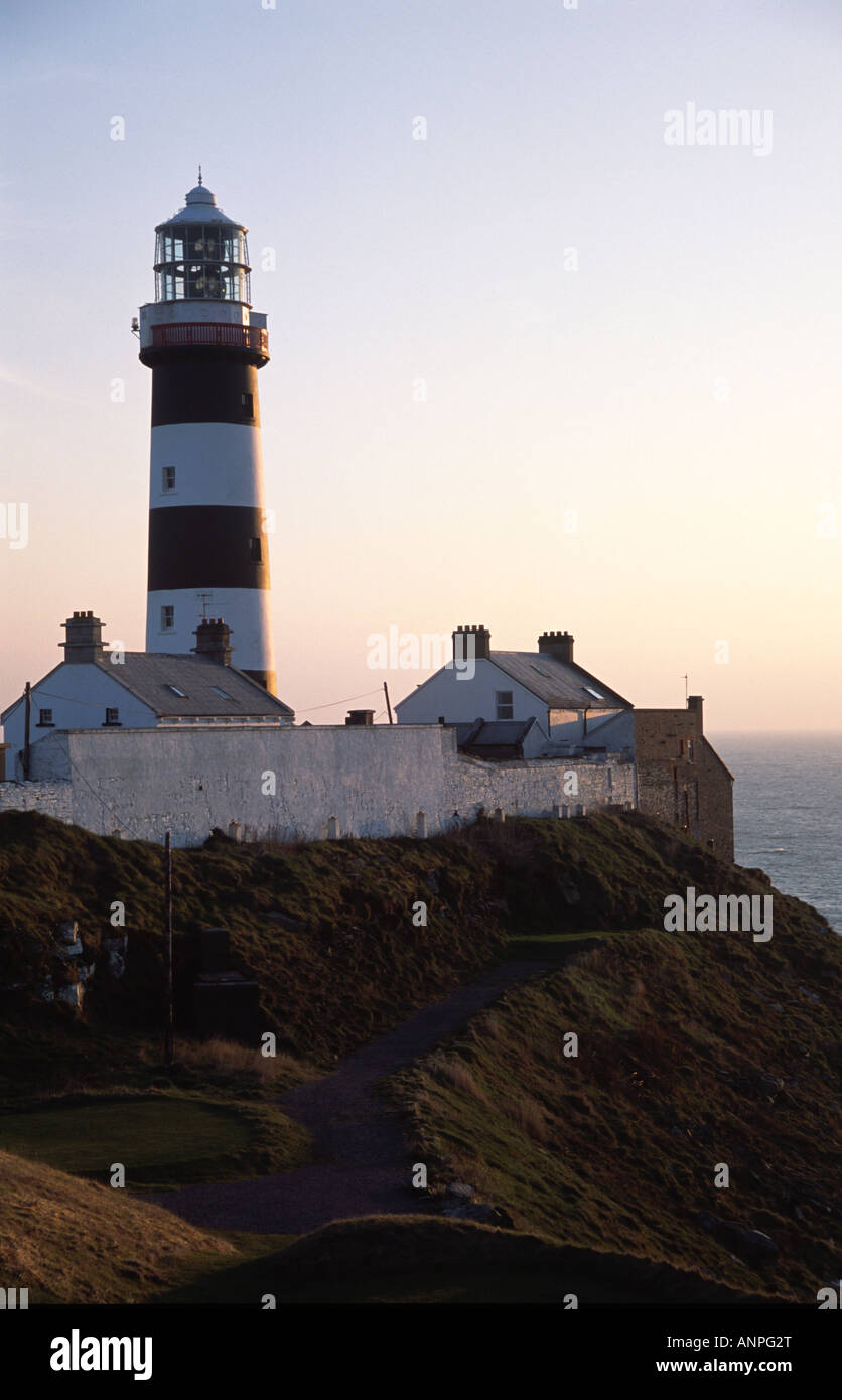 The old head of Kinsale lighthouse and standing stone, Cork, Ireland ...