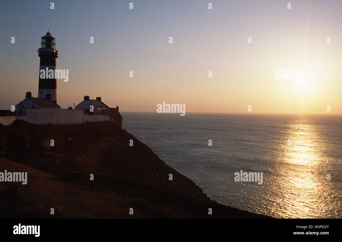 The old head of Kinsale lighthouse and standing stone, Cork, Ireland ...