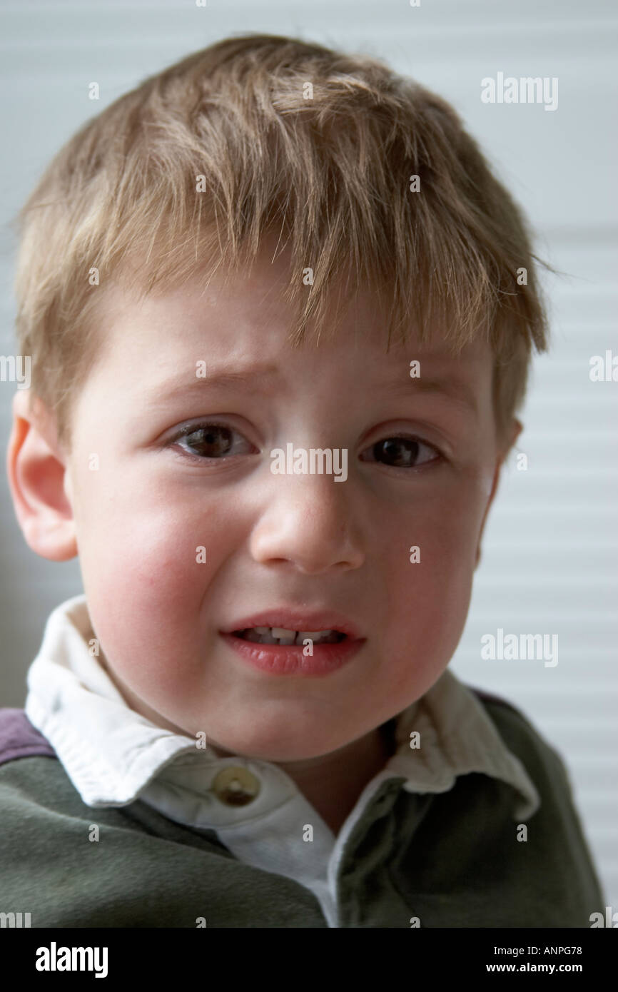 Small young boy looking sad miserable and worried CJWH Stock Photo - Alamy