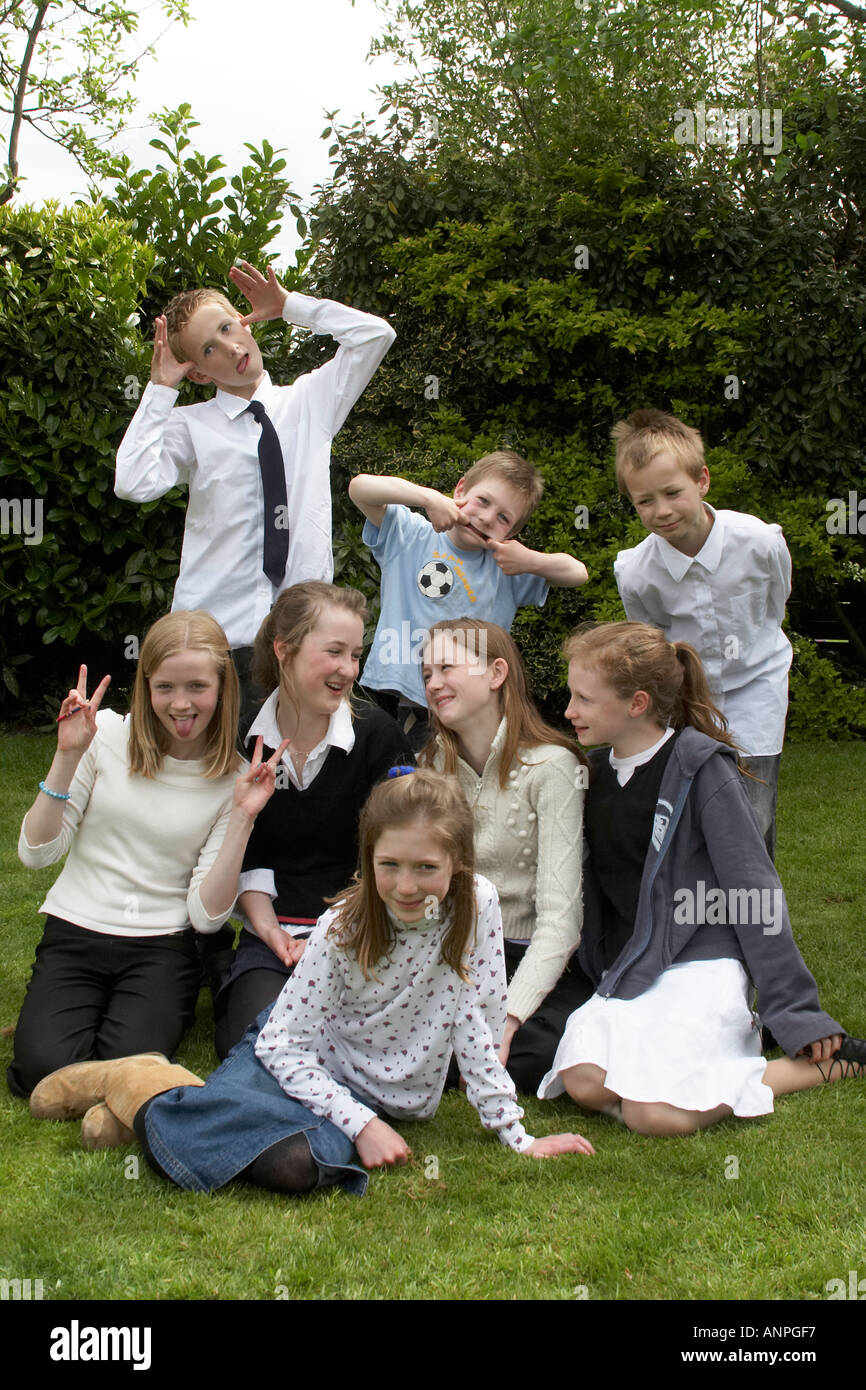 Family group of children cousins outdoors in a garden making silly ...