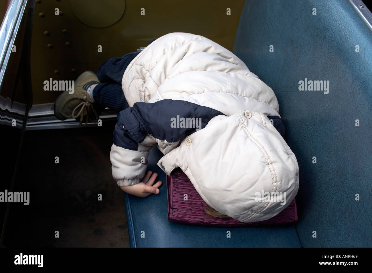 Young boy asleep on a bus seat Stock Photo - Alamy