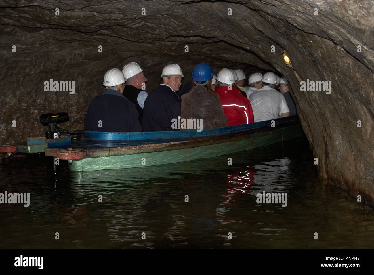 Tourist visitors on a boat inside Speedwell Cavern Castelton Peak ...