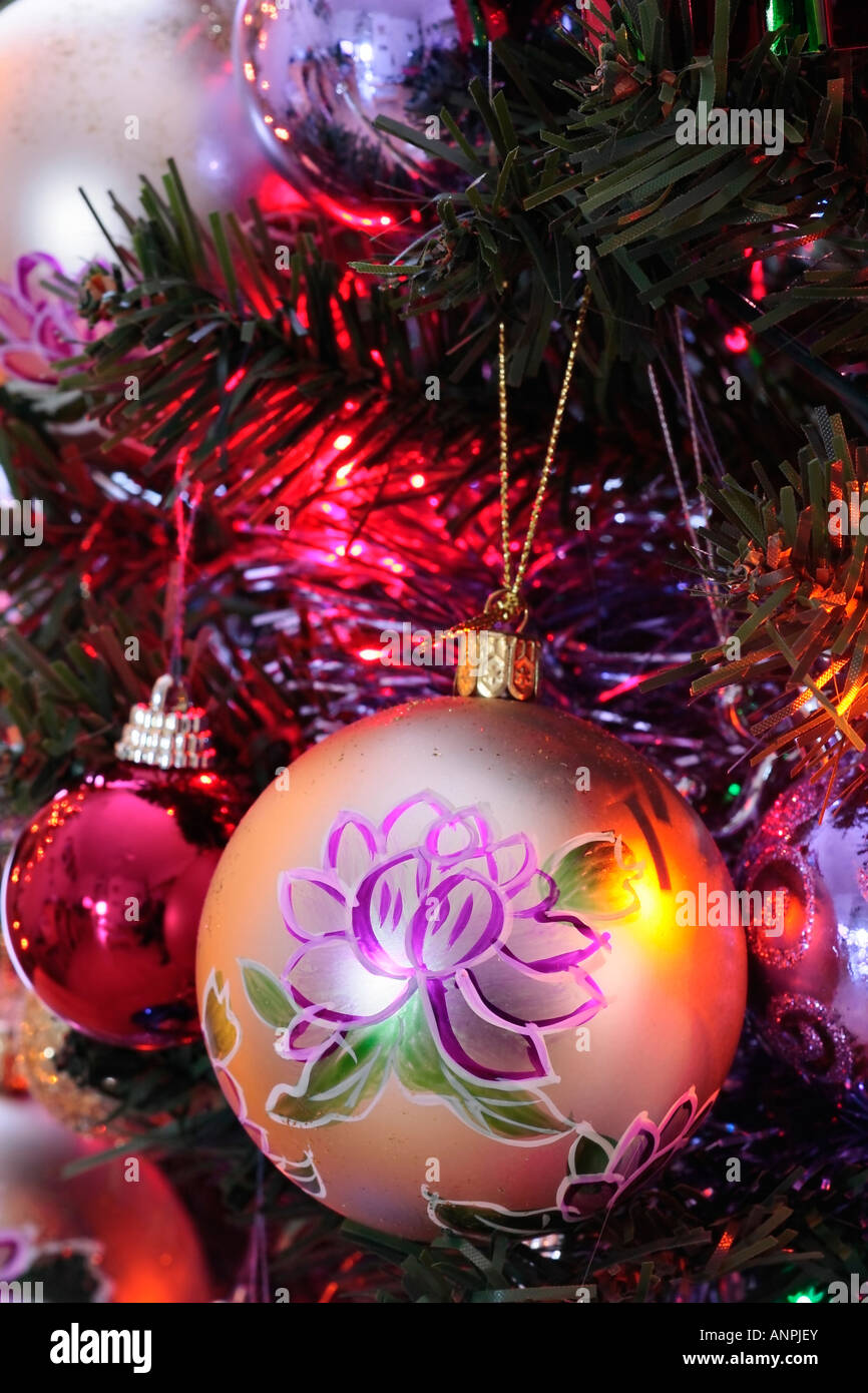 A close up of a large hand painted glass bauble on a tree at Christmas ...