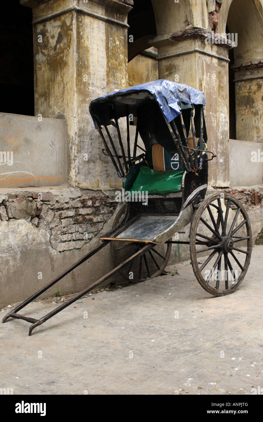 A hand-pulled rickshaw stands unattended in Sudder Street, Kolkata ...
