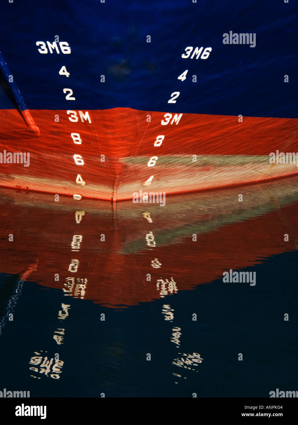 Draught marks and hull of a tug reflected in calm water, Lyttelton, New ...