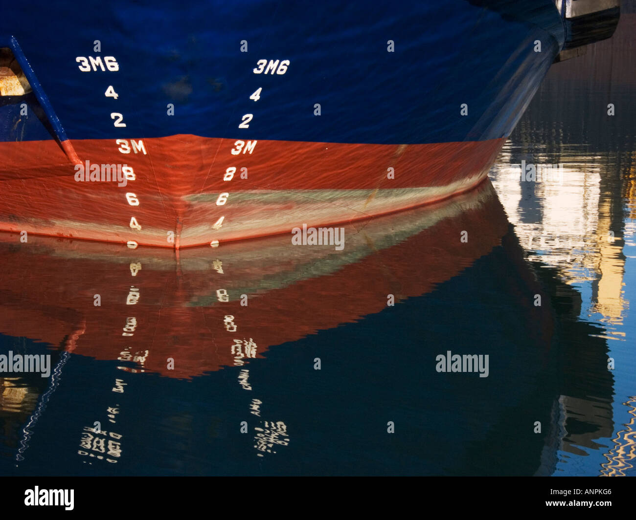 Draught marks and hull of a tug reflected in calm water, Lyttelton, New ...
