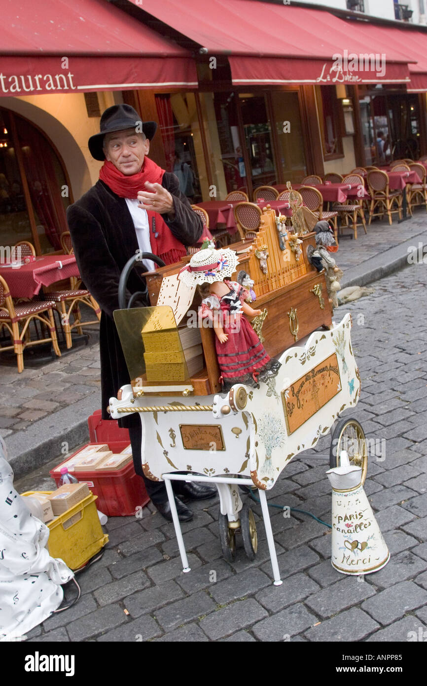 Street musician playing organ and singing in the Place du Tertre ...