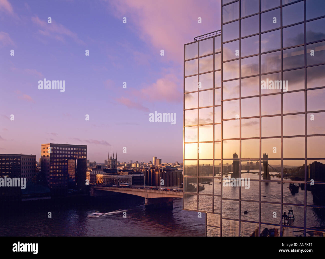 Dawn over London Bridge and River Thames with Tower Bridge reflected in ...