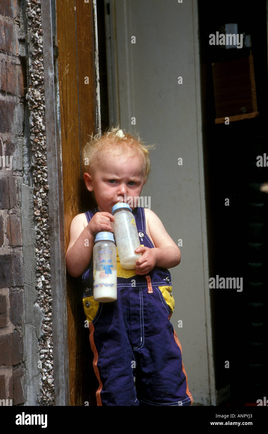 Council Estates young child drinking from feeding bottle Stock Photo ...