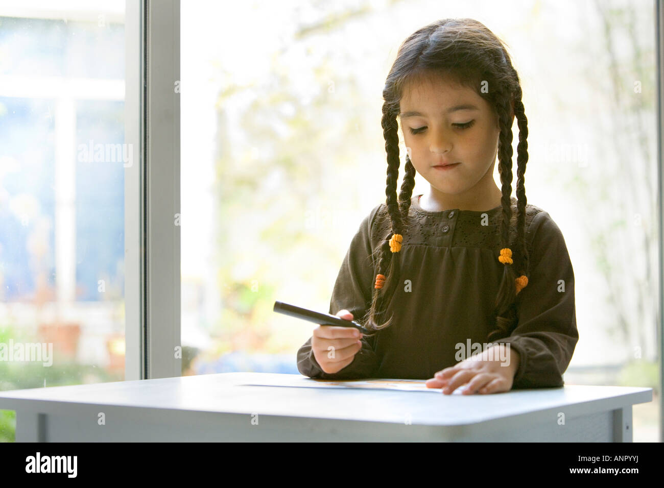 Little girl with a colouring pen Stock Photo - Alamy