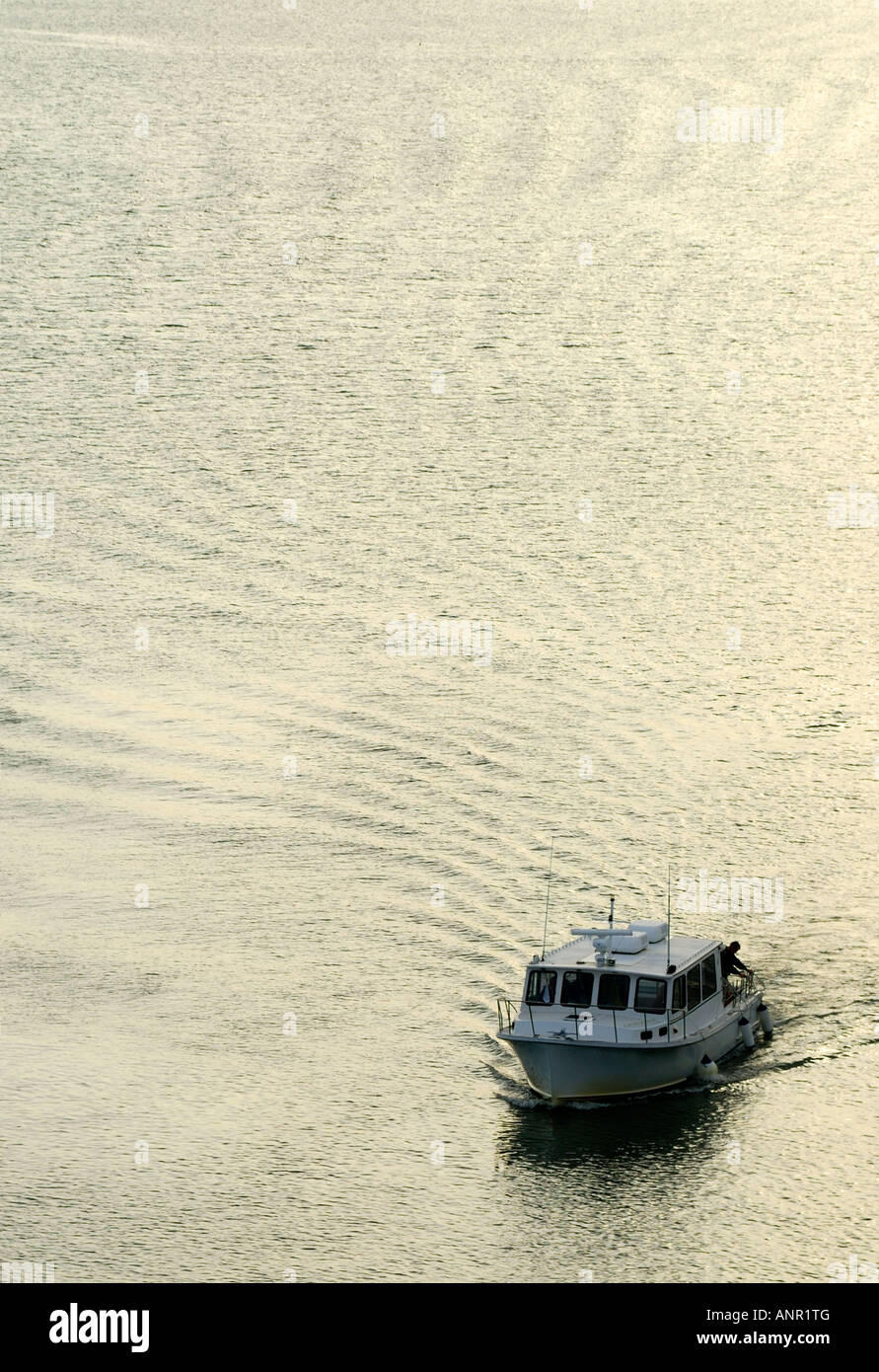 Ferry boat sliding thru the water in the golden light of the evening ...