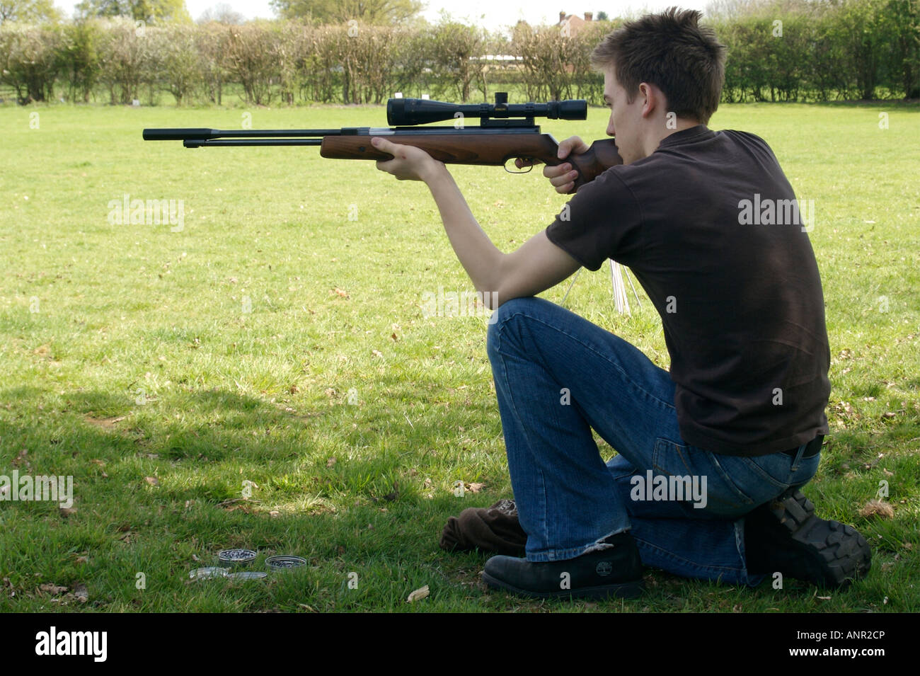 A youth takes aim with a rifle Stock Photo - Alamy
