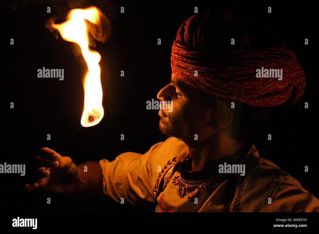 Indian fire-eater with turban Stock Photo - Alamy