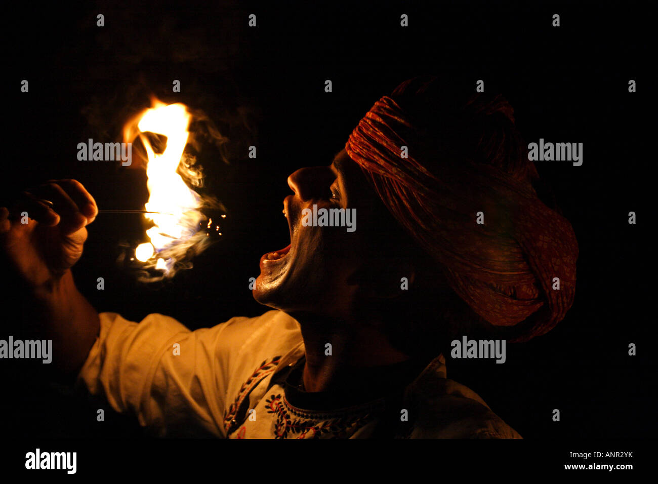 Indian fire-eater with turban Stock Photo - Alamy