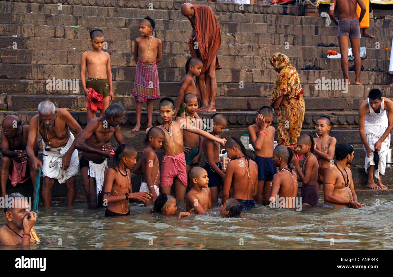 A group of young brahman priest pupils taking a bath at dawn in the ...