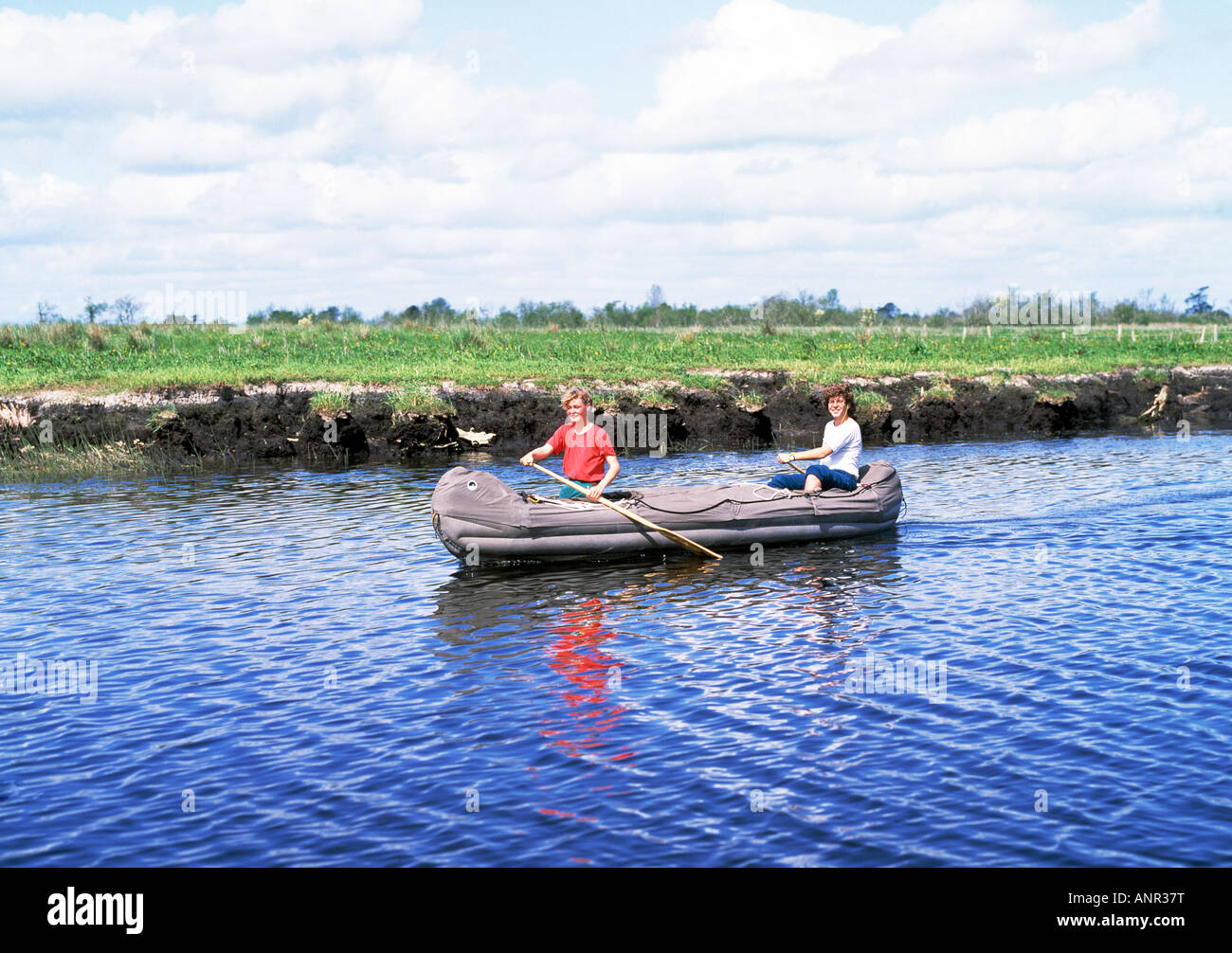 two people rowing along an irish river Stock Photo - Alamy