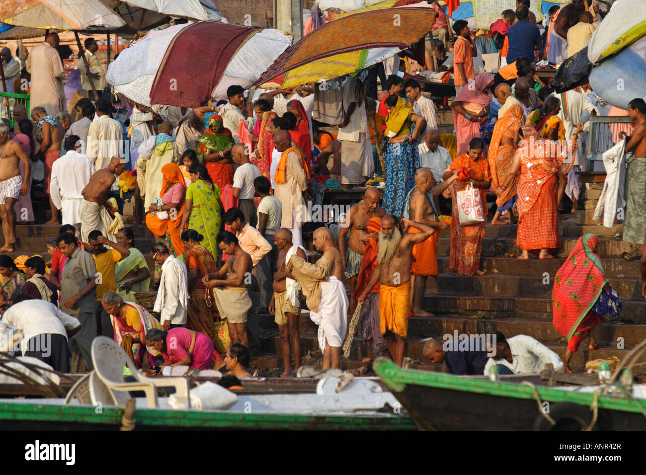 Pilgrims during their daily morning service at the ghats of Varanasi ...