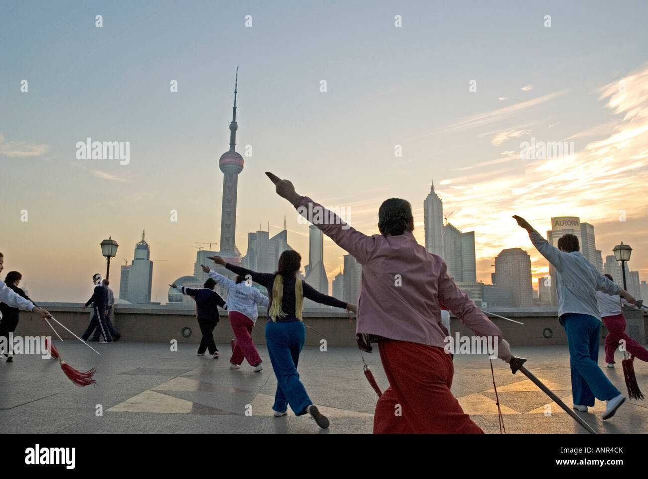 Women team doing morning exercise with swords on the Bund, Shanghai ...